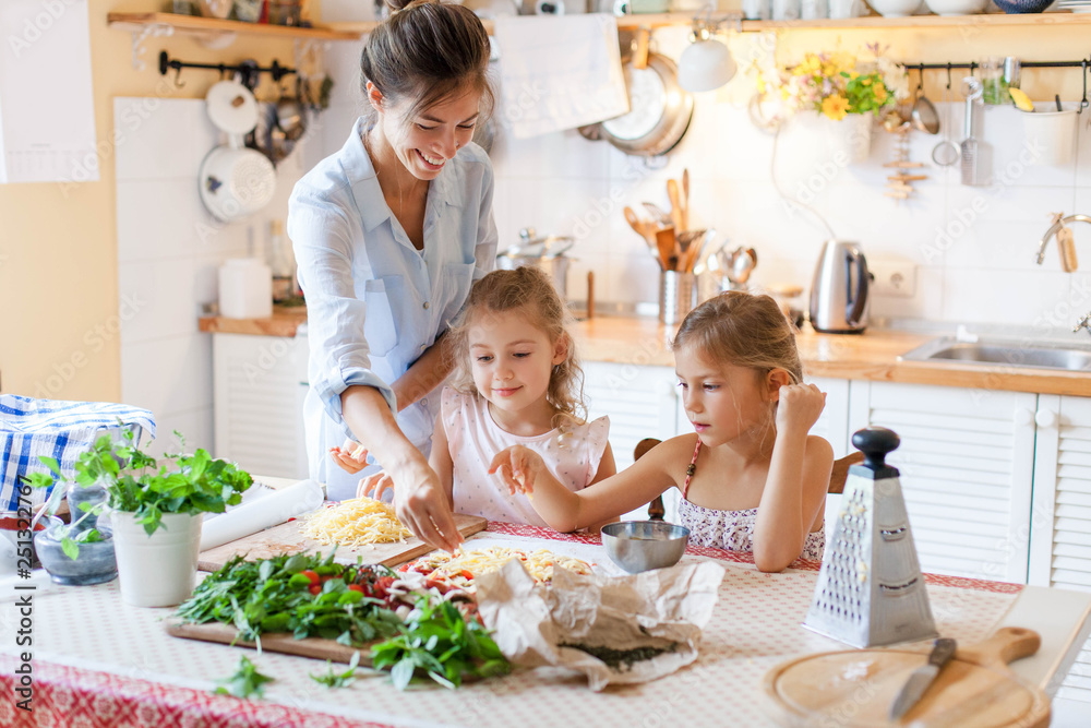 Family are cooking italian pizza together in cozy home kitchen. Cute ...
