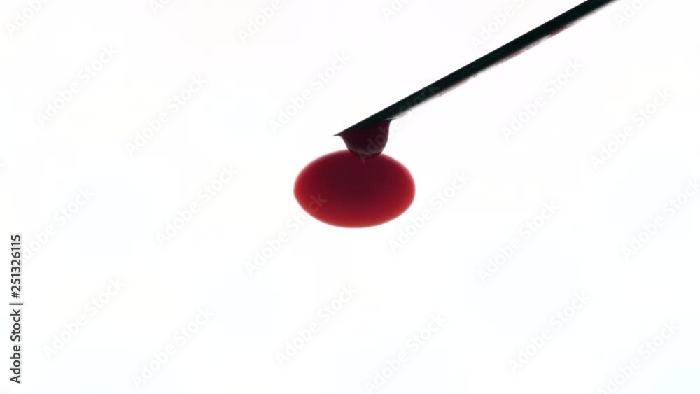 Close-up red blood dripping from syringe needle high angle isolated at ...