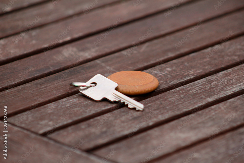 Hotel suite key with wooden fob for room on wood table. Room key on ...