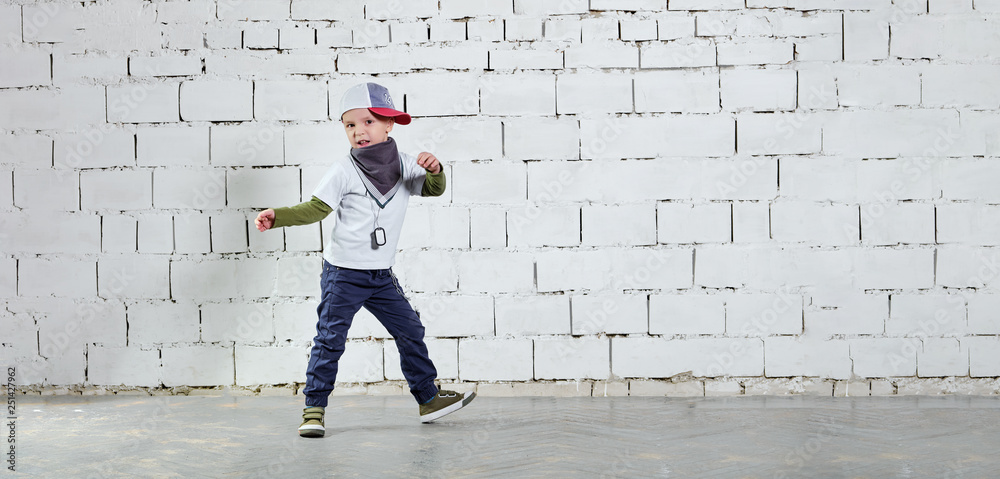 Child model posing in young rapper clothes. Cool kid boy dancing break ...