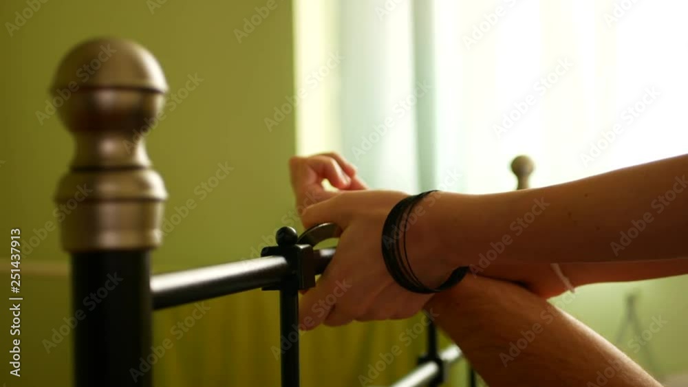 Man with a purple handcuff tied to the bed by woman สต็อกวิดีโอ | Adobe ...