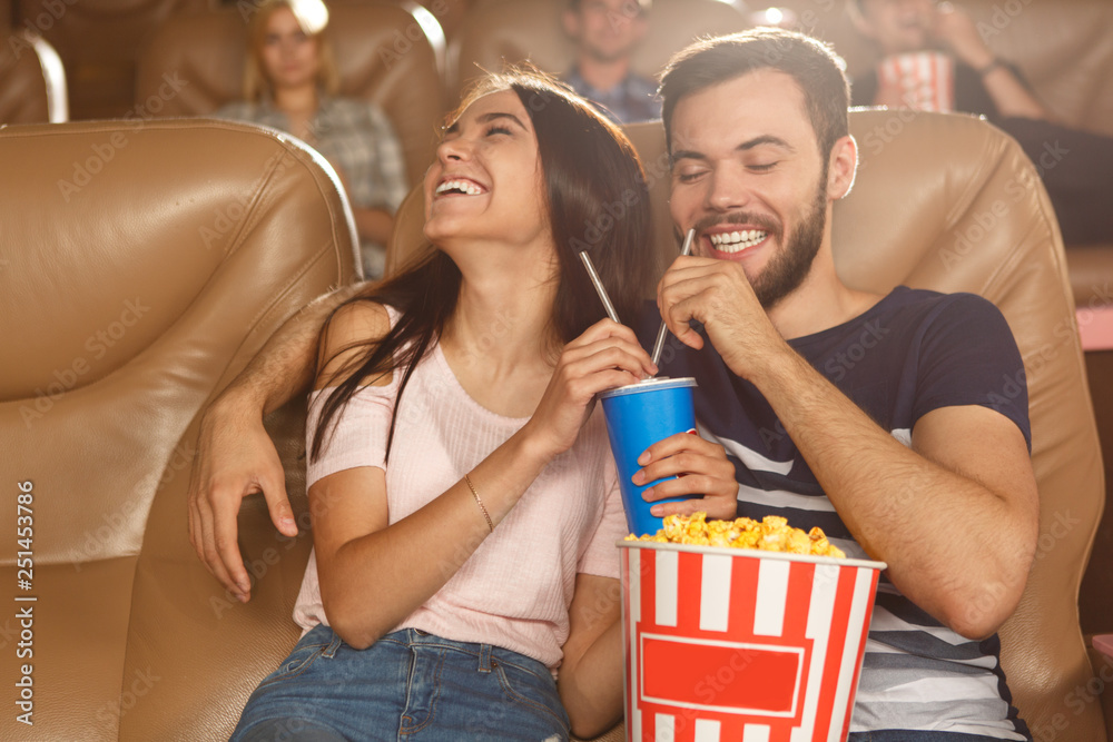 Girlfriend and boyfriend laughing together during watching funny comedy ...