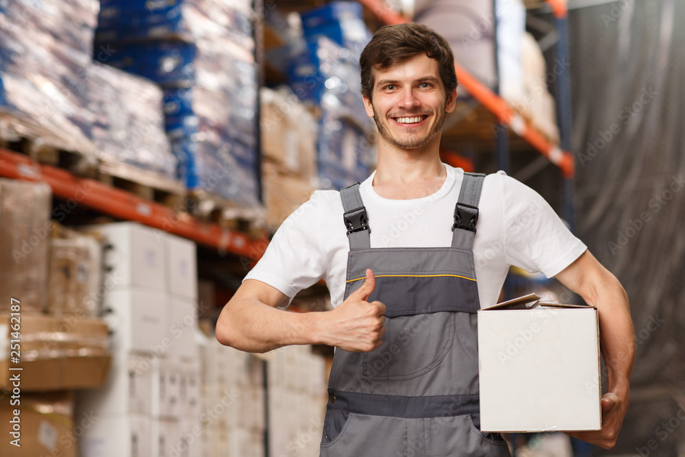 Foto de Front view of handsome worker in uniform smiling and posing ...