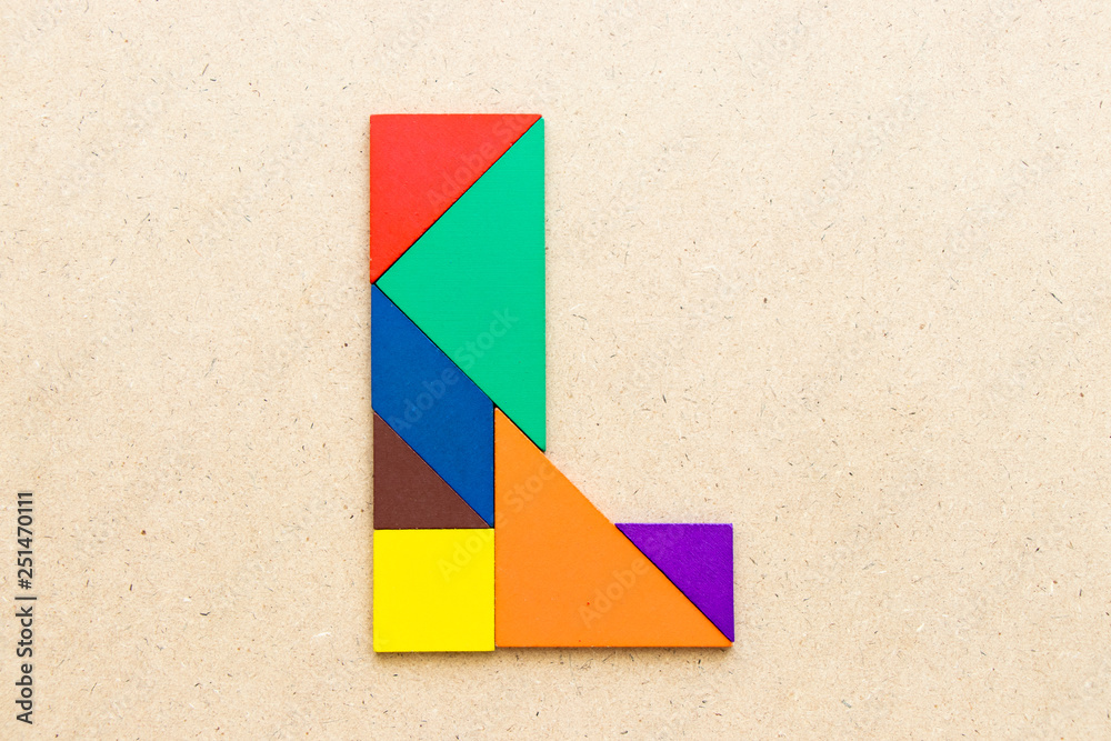 Tangram puzzle in alphabet letter L shape on wood background Stock ...
