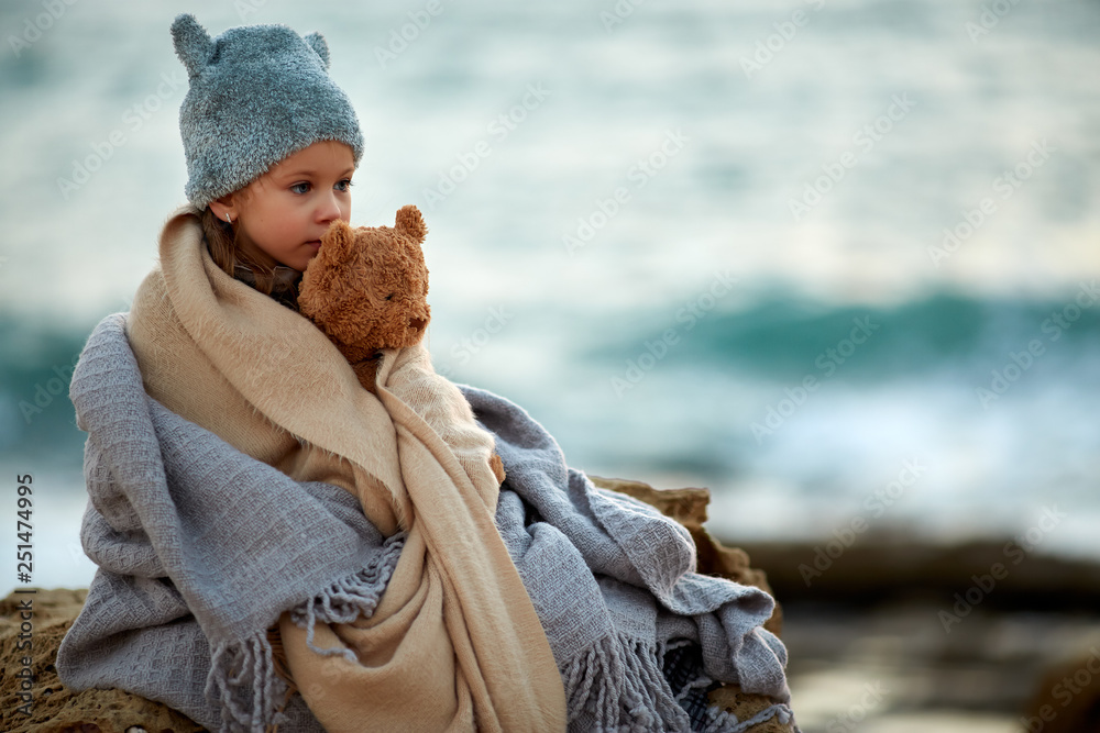 Charming girl with teddy bear cuddling in plaid Stock Photo | Adobe Stock