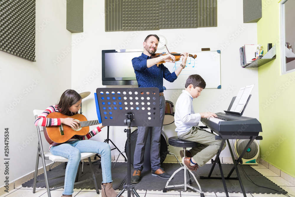 Teacher And Pupils Playing Various Instruments In Class Stock Photo ...