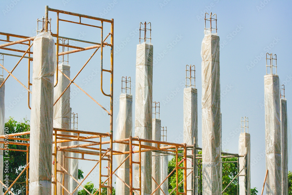 Reinforced concrete pole of the new house building with clear plastic ...