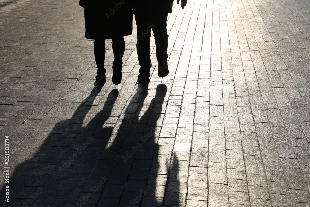 Two People Walking In The Street