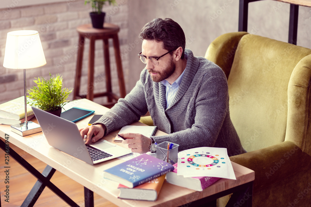Nice smart man pressing the button on his laptop Stock Photo | Adobe Stock