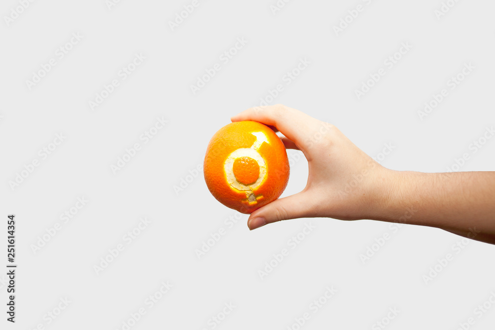 Gender equality. Orange with the sign of gender equality in the hand of ...