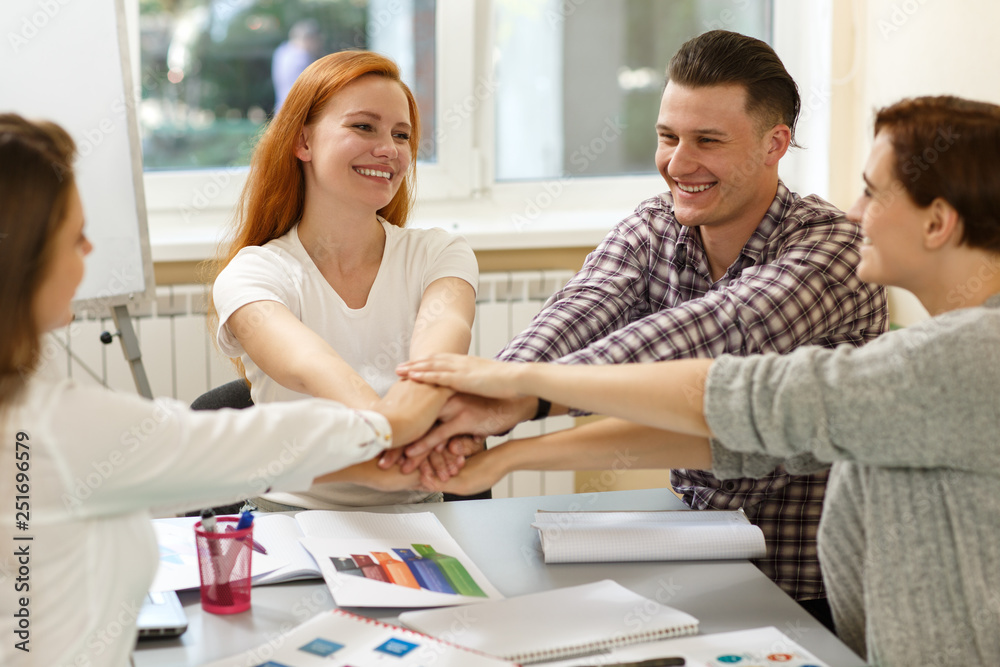 Smart determined learners giving fives during working in group in ...