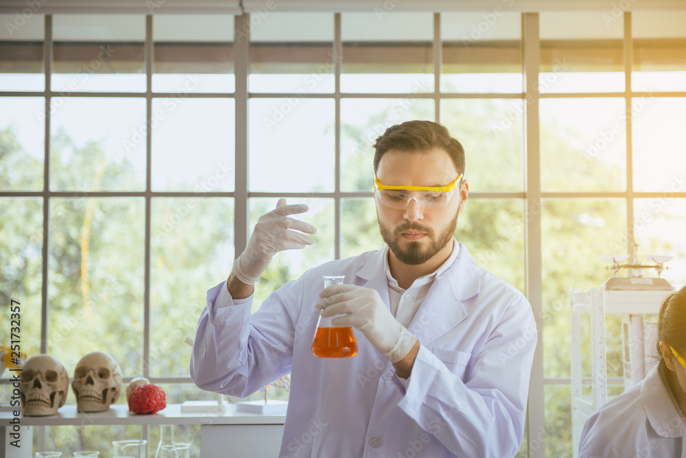 Scientist man working smelling test and putting medical chemicals ...