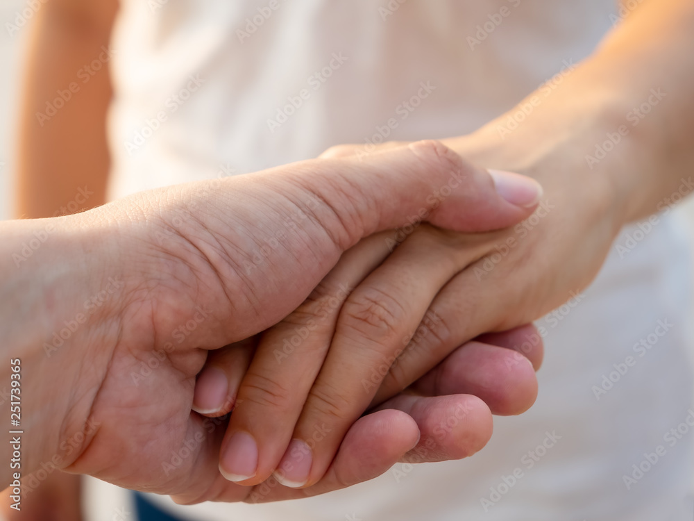 Businessman with client holding hands together for comfort and support ...