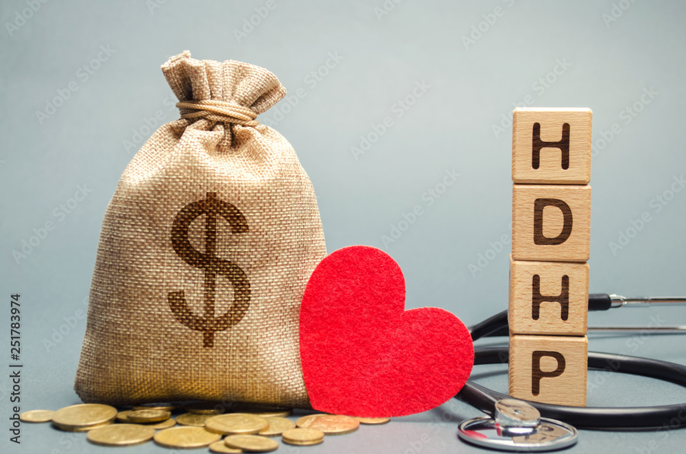 Wooden blocks with the word HDHP and money bag with dollar sign. High ...