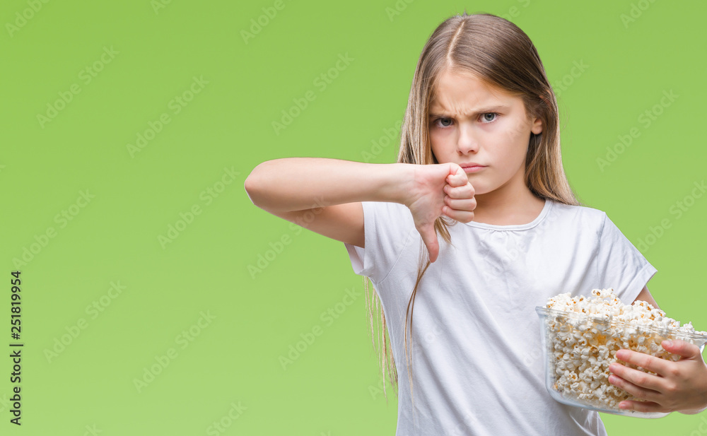 Young beautiful girl eating popcorn snack isolated background with ...