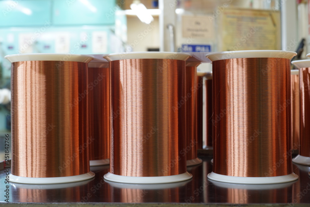 Standard copper wire enamel in a bobbin on the table, steel floor in ...