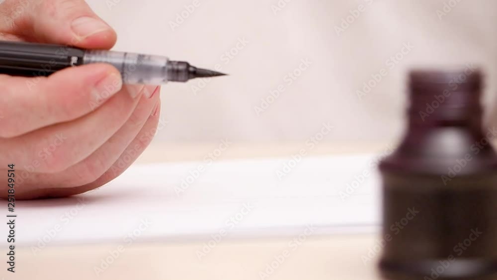 Mans hands open brush pen and inkpot. Preparing for calligraphic ...