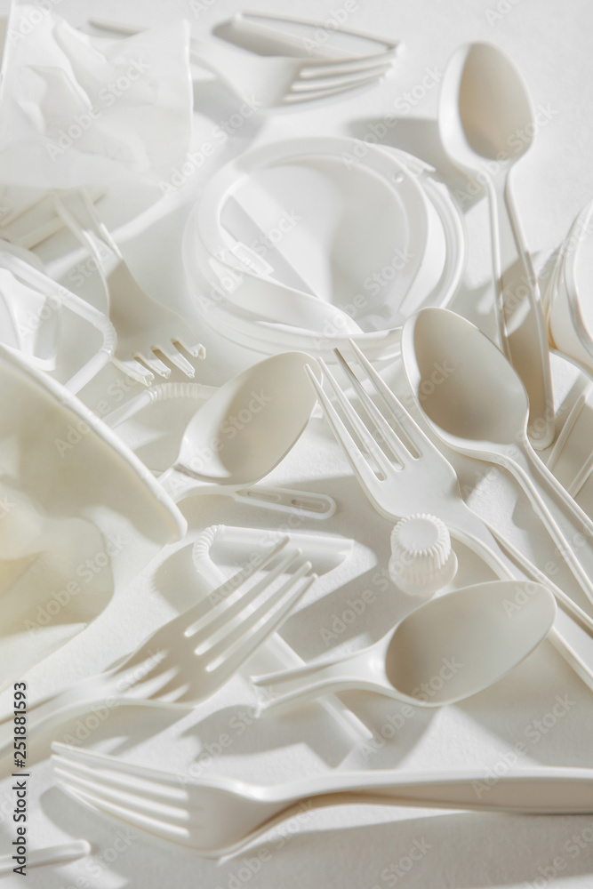 White single use plastic on white background. Closeup. .Concept of ...