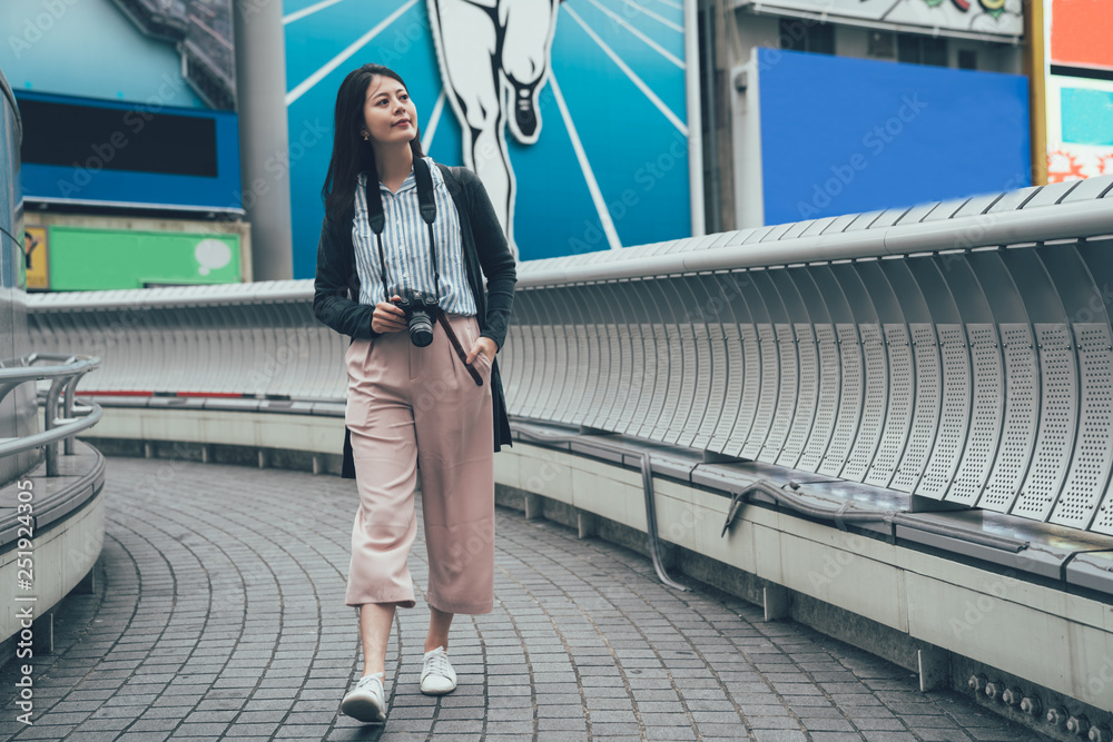 full length of young japanese lady visiting osaka city japan on weekend ...
