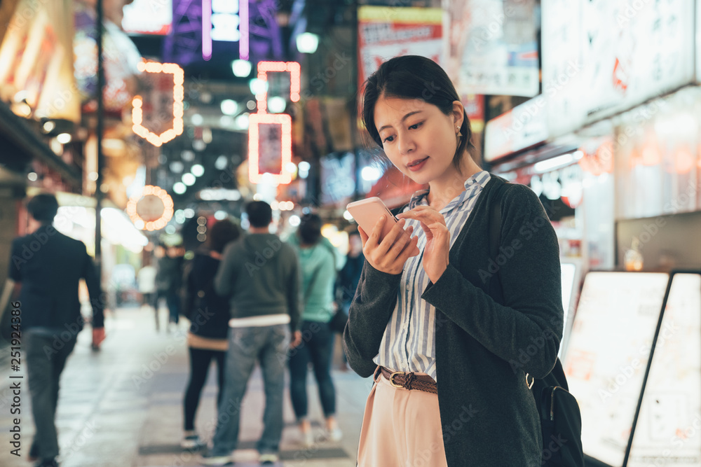 vintage style of young japanese woman texting sms cellphone in city at ...