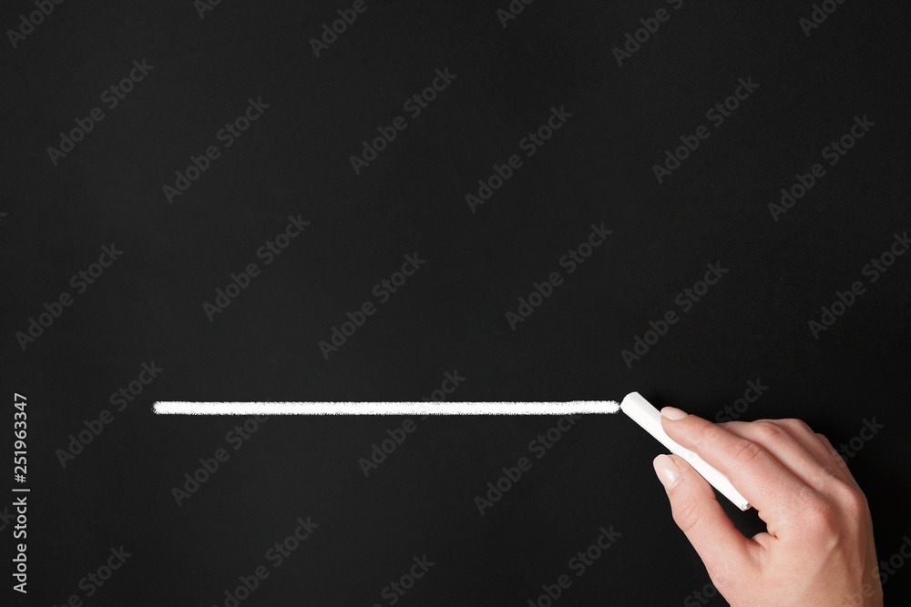female hand drawing chalk line on chalkboard - blackboard background ...