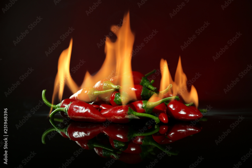 Red hot chili peppers with fire on dark color background Stock Photo ...