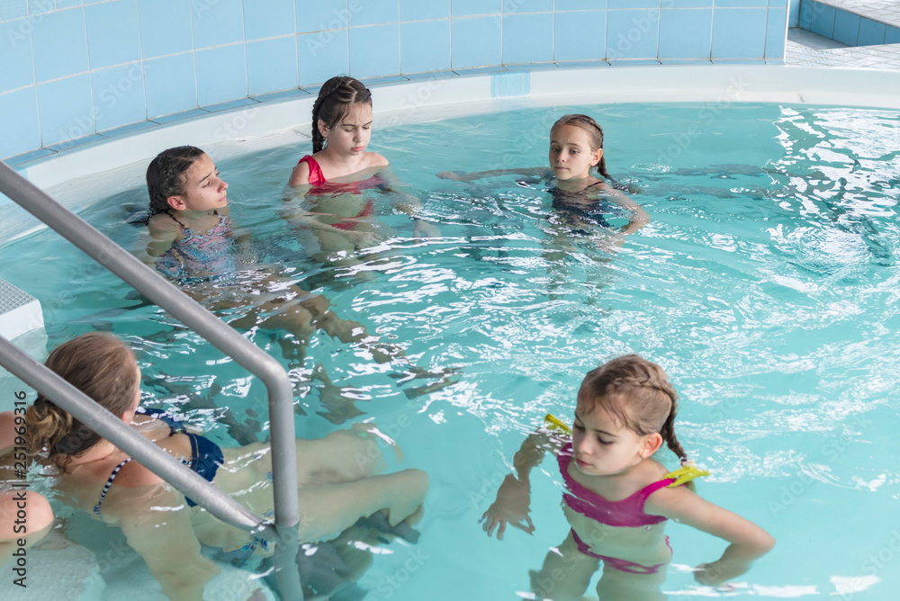 Girls swim in the pool. Happy girls play in the pool.Beautiful girls ...