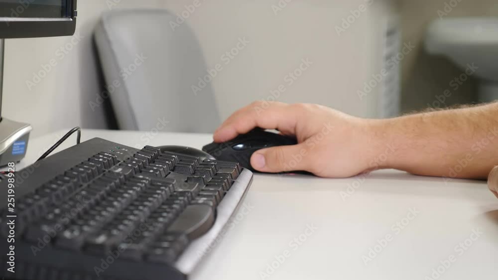 Male hand clicking computer mouse with black keyboard near. In dental ...