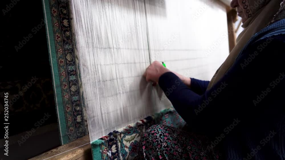 Traditional woman weaving Turkish carpet. Making Persian carpet by hand ...