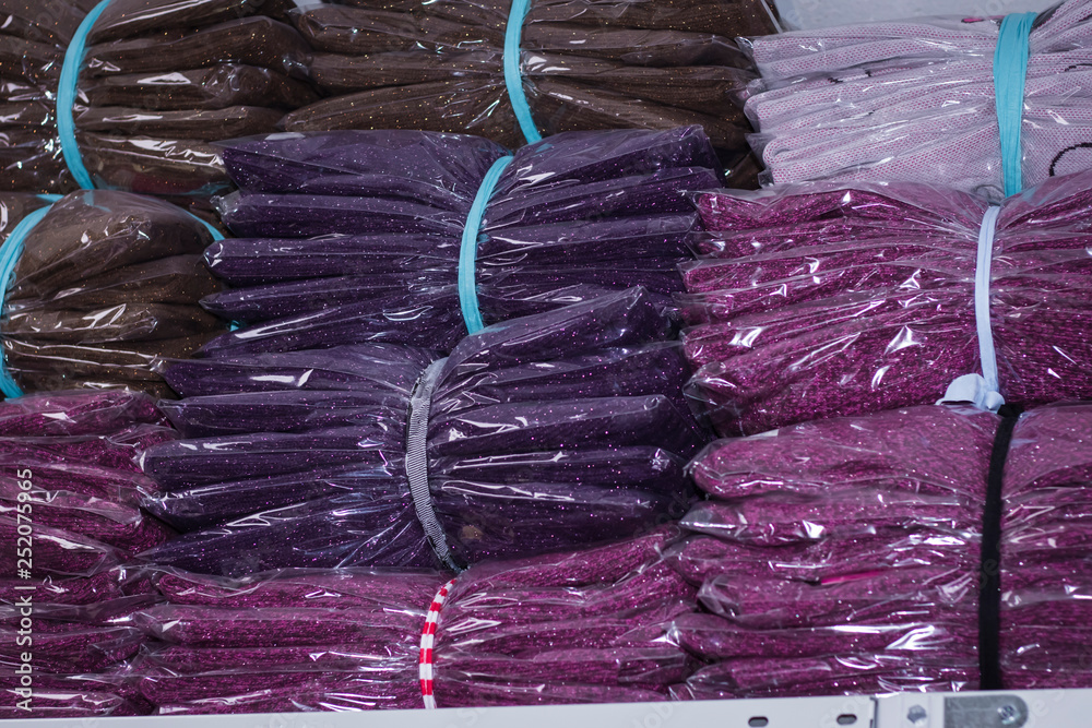 Different sizes of clothing in the store on the shelves in the package ...