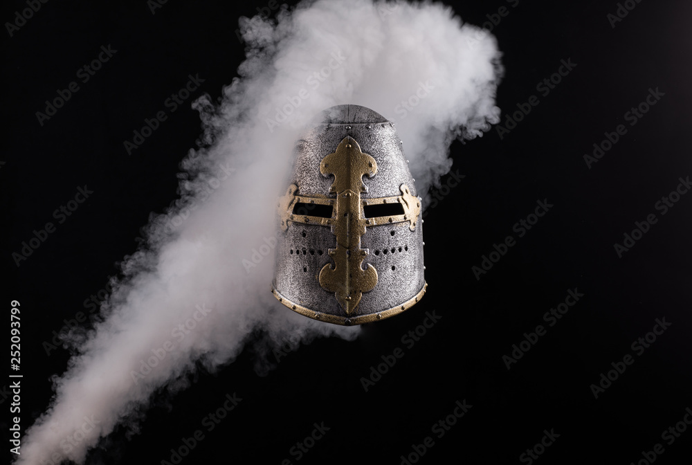 medieval knight's helmet on a black background Stock Photo | Adobe Stock