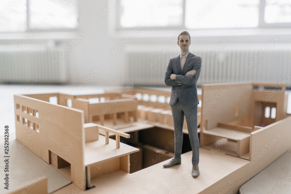 Miniature businessman figurine standing in architectural model Stock ...