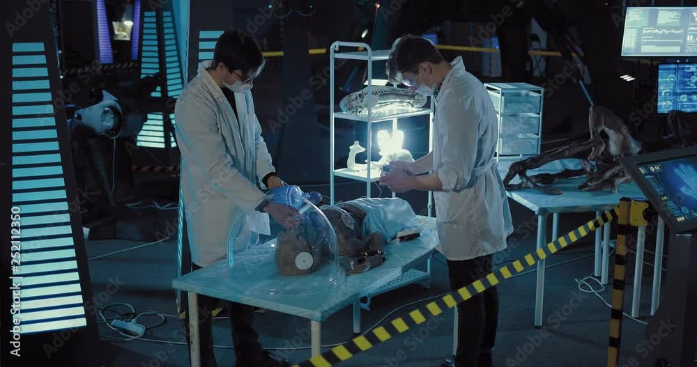 Alien connected to a respirator, lying on the operating table ...
