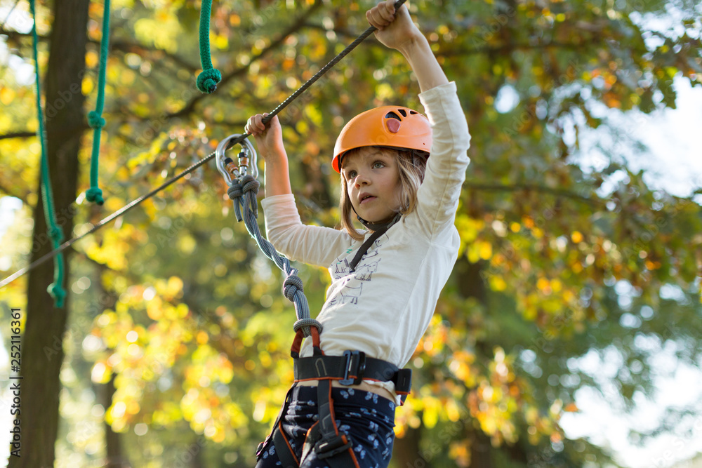 Little girl in ropes course adventure park Stock Photo | Adobe Stock