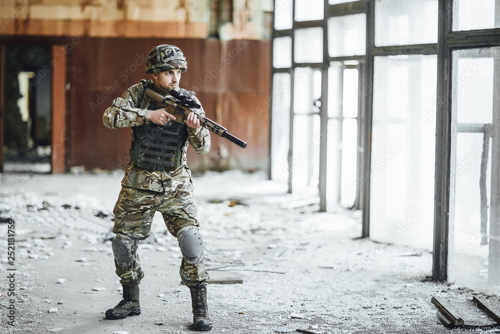 Patrols the territory! The young soldier in the military stands at the ...