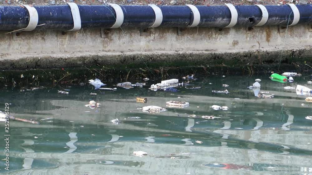 Trash and garbage floating on the surface of the water. Water pollution ...