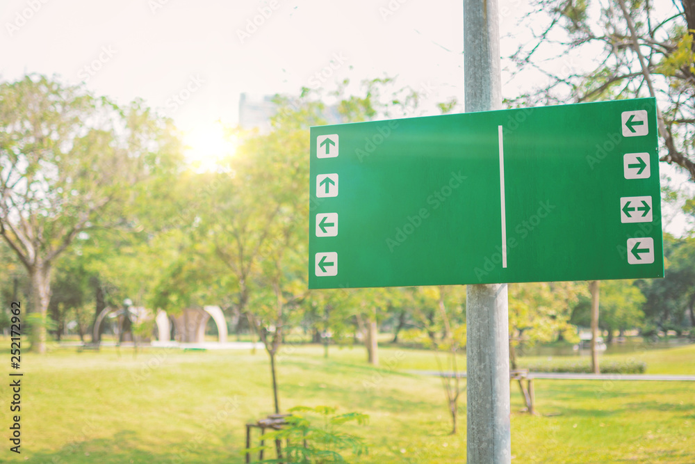 Public park with empty green trailhead sign showing multiple trails and ...
