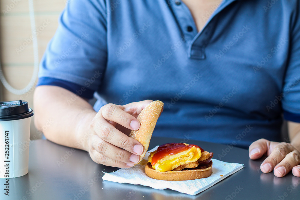 Diet failure of fat man eating fast food hamberger. Happy smile ...