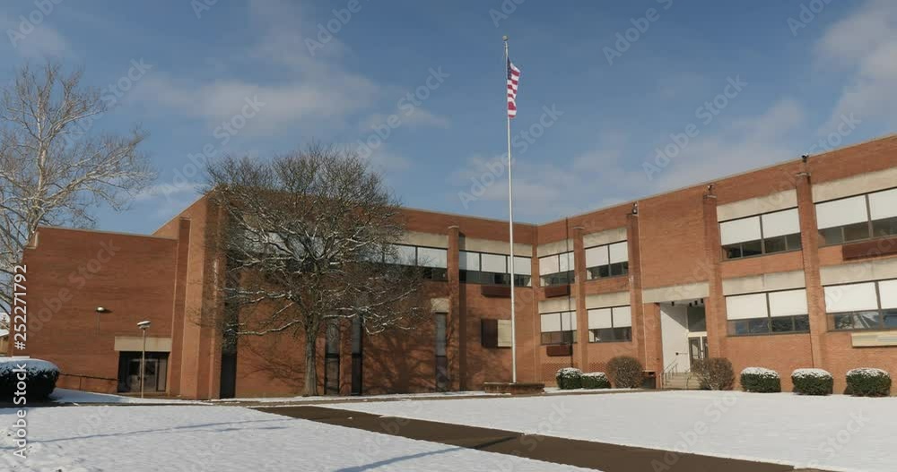 A daytime winter establishing shot of a typical two-story red brick ...