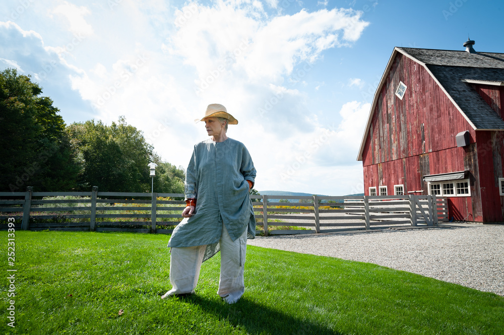 Woman poses in front of barn Stock Photo | Adobe Stock