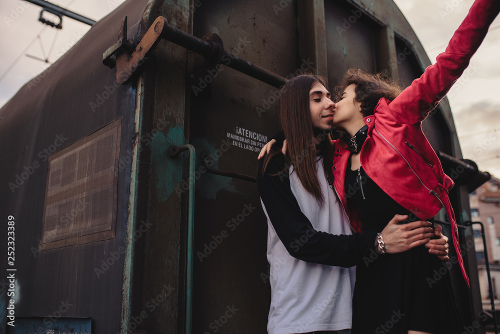 Long haired man hugging and kissing woman near train Stock Photo | Adobe Stock