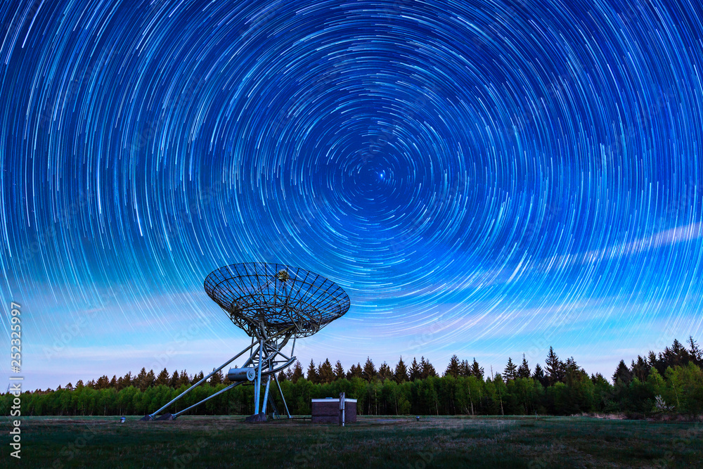 Radar at night, with a light cloudy sky, stars and startrails. Stock ...