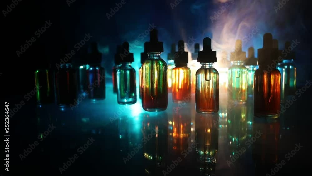 Vape concept. Smoke clouds and vape liquid bottles on dark background ...