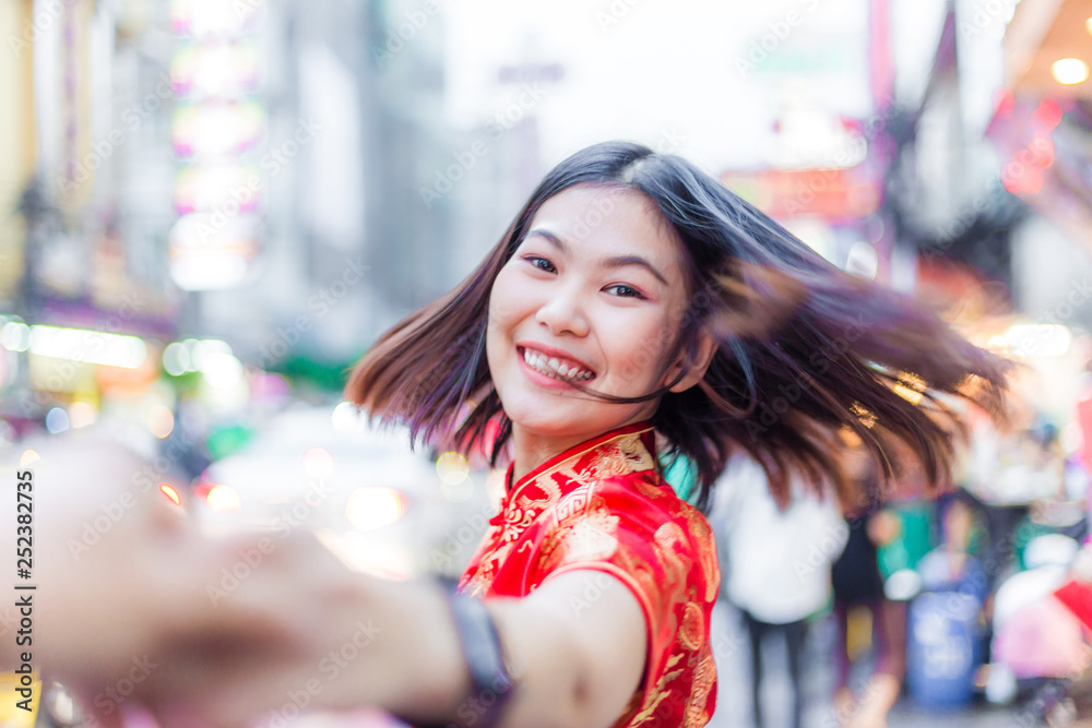 Beautiful women in Chinese suit leading man hand to travel in Chinese ...