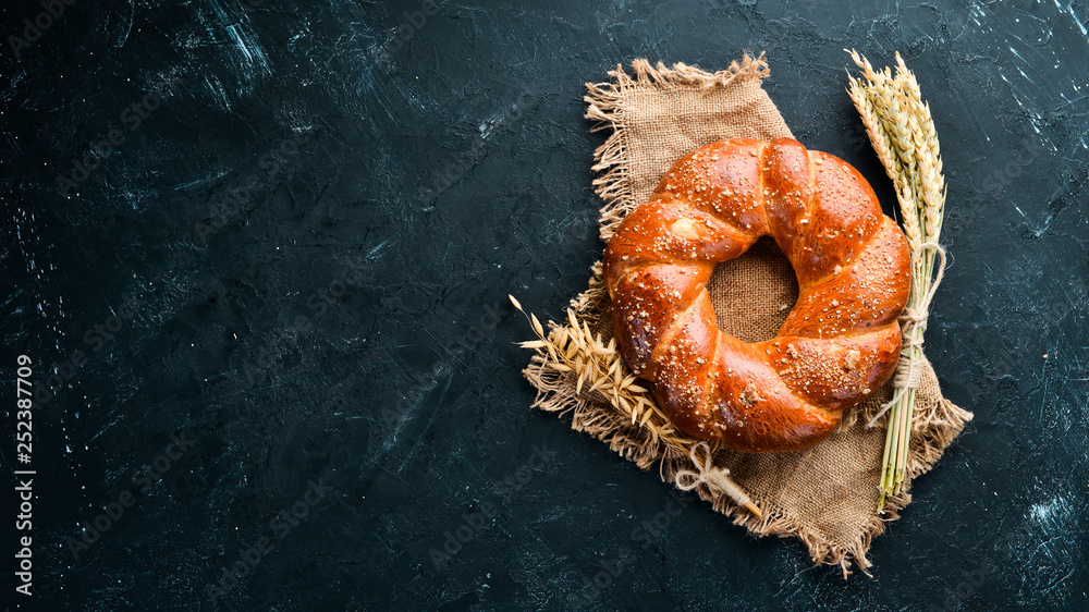 Round braided loaf of bread flour. Top view. Free space for your text ...
