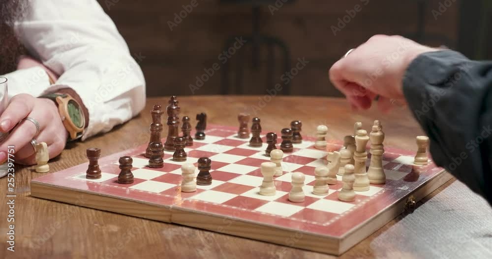 Chess board covered in heavy smoke during a game. Male hands moving ...
