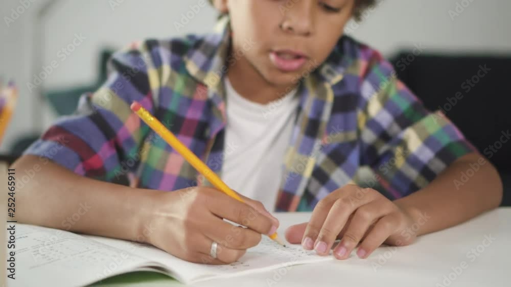 Cropped and close up view of smart, focused and concentrated little boy ...