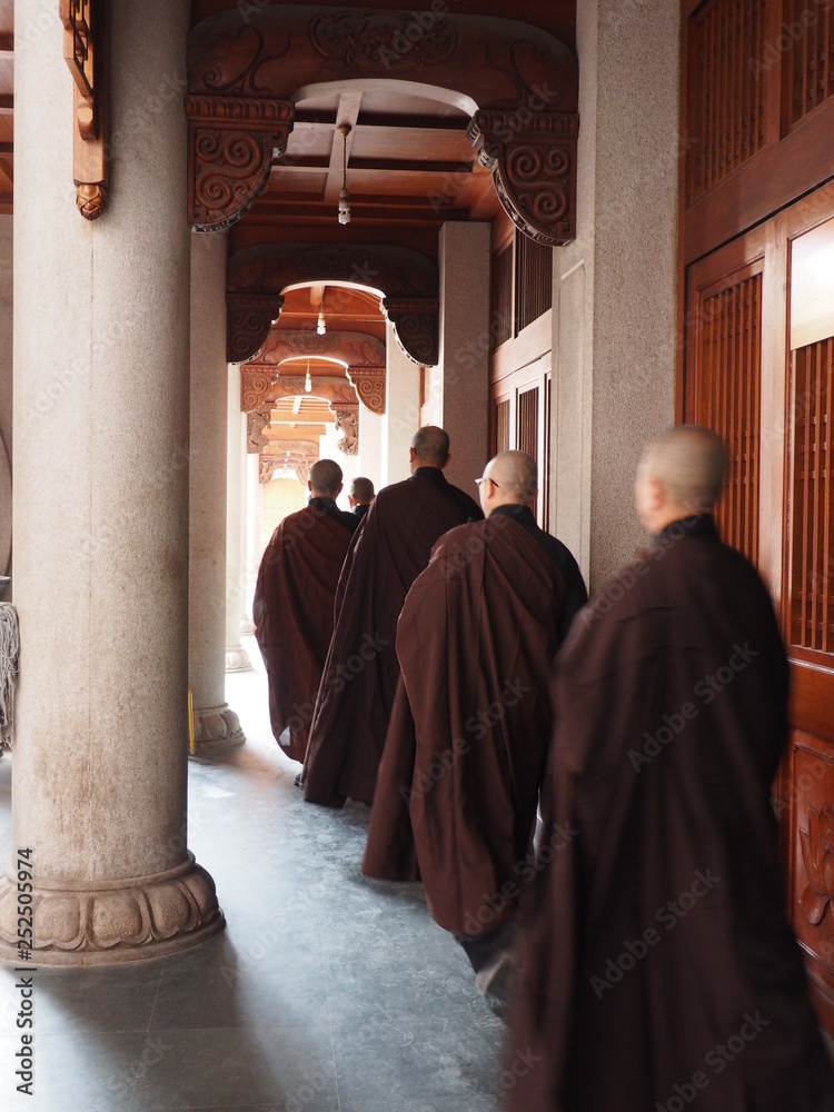 Buddhist Monks walking down temple corridor Stock Photo | Adobe Stock