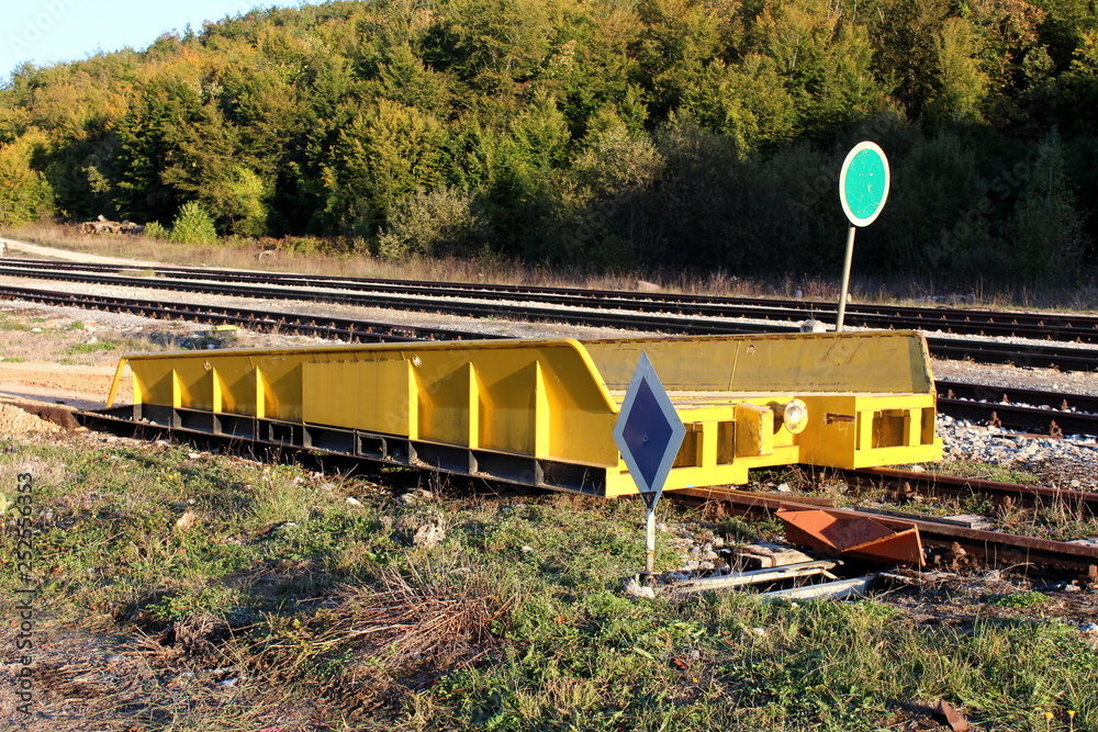 Yellow strong metal railway loading ramp mounted on railway tracks next ...