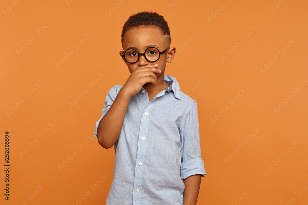 People and lifestyle. Handsome serious black schoolboy in round eyewear ...